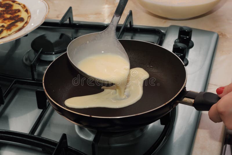 Pouring the Dough into the Hot Pan by Ladle Stock Photo - Image of ...