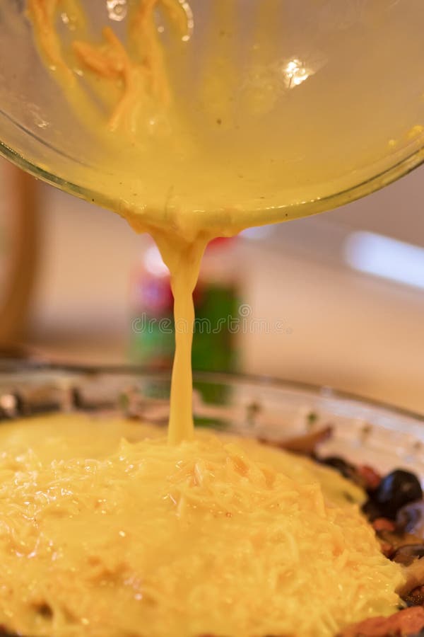 Pouring Egg and Cheese Mix stock image. Image of food - 115752177