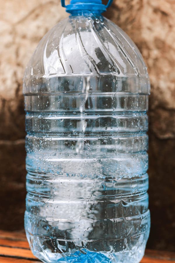 Pouring Fresh Spring Water into Plastic Bottle from a Natural Source ...