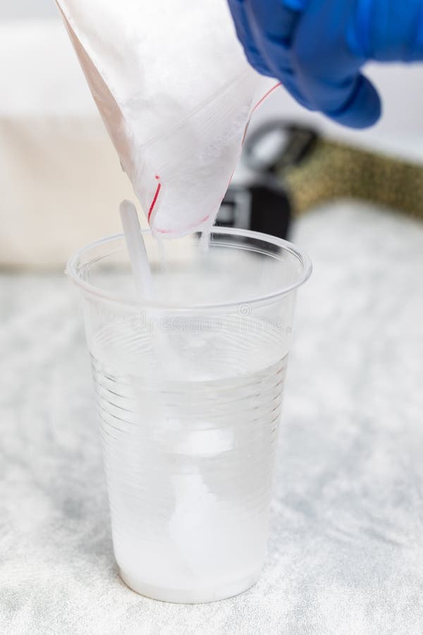 Pouring Glucose Powder into Water for Glucose Tolerance Test Stock ...