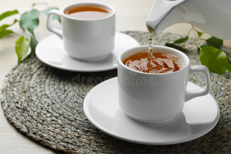 Pouring Green Tea into White Cup with Saucer on Table, Closeup Stock ...