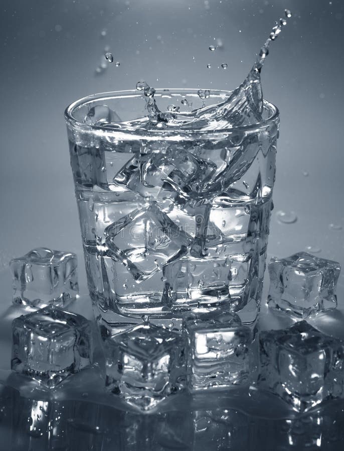 Pouring Ice Cube into Drink Glass of Water. Splashing Water. Stock ...