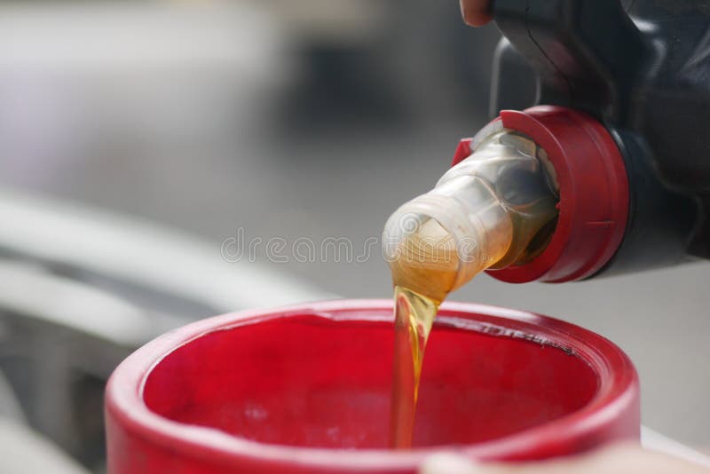 Pouring Liquid into Red Funnel for Engine Maintenance Stock Photo ...
