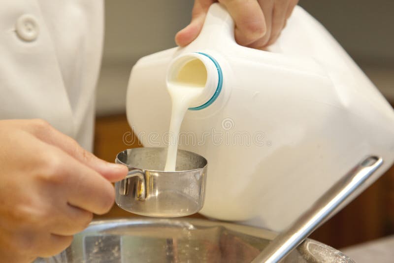 Pouring milk while baking stock image. Image of container - 130076489