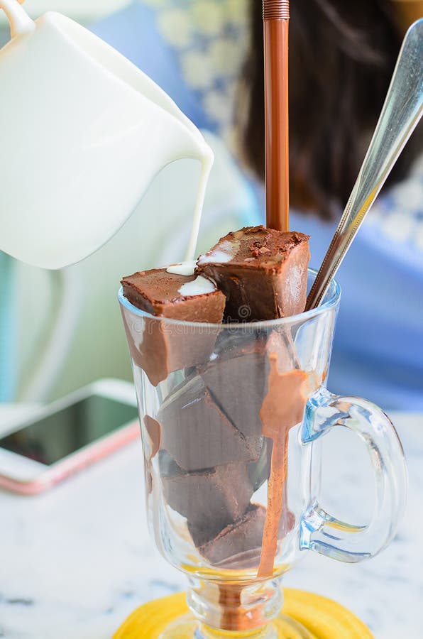 Pouring Milk in a Cup of Cube Chocolate Ice Cream. Stock Image - Image ...