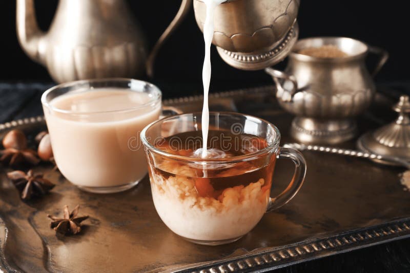Pouring of Milk into Glass Cup with Tea on Tray Stock Photo - Image of ...