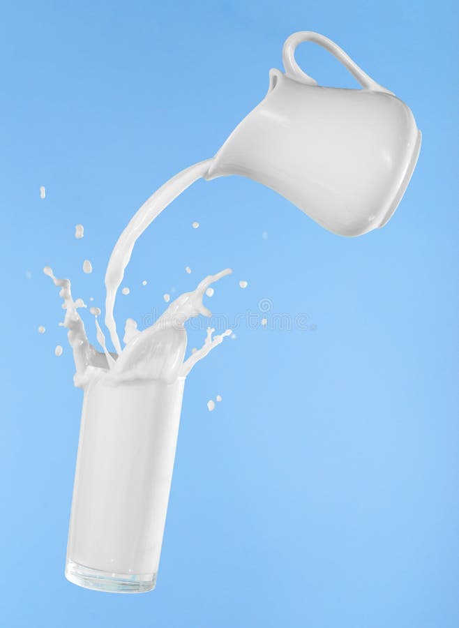Pouring Milk from Jug into Glass Cup with Splashing on Blue Background ...