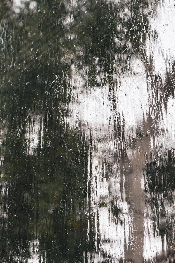 Pouring Rain Covering the Window during a Storm; Blurred Tree Shape ...