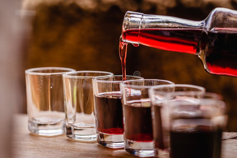 Pouring Red Alcohol Shots in Small Glasses on a Celebration Stock Photo ...