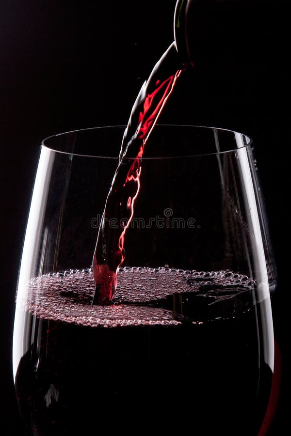 Pouring red wine stock image. Image of glassware, merlot - 18487845