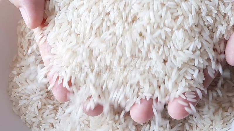Pouring Rice from hands stock video. Video of full, close - 285677629