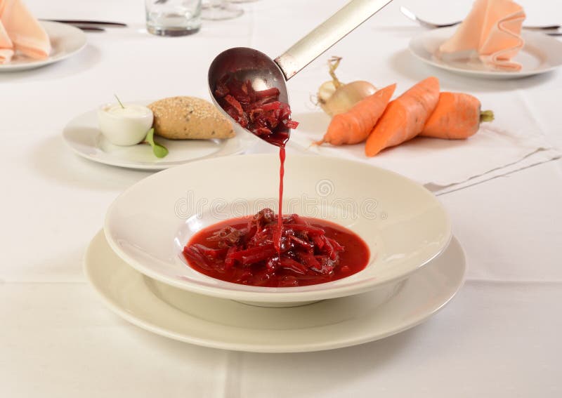 Pouring Soup in a Plate on Served Table with a Ladle Stock Photo ...
