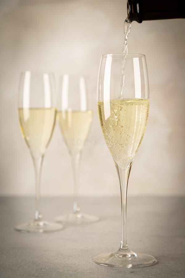 Pouring sparkling wine stock photo. Image of luxury - 261061916