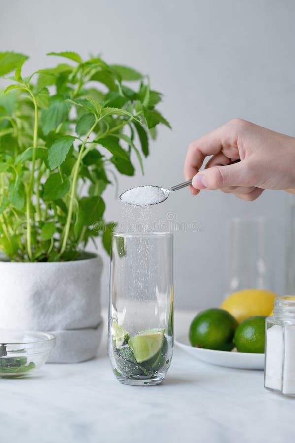 Pouring Sugar in Glass with Lime and Mint, Kitchen Table with Mojito ...