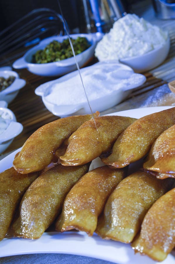 Pouring Syrup on Qatayef, Arabic Sweets with Nuts for Ramadan an Stock ...