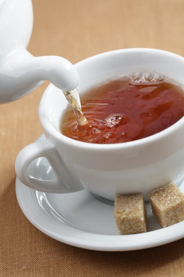 Pouring Tea Stock Photos - Download 12,594 Royalty Free Photos