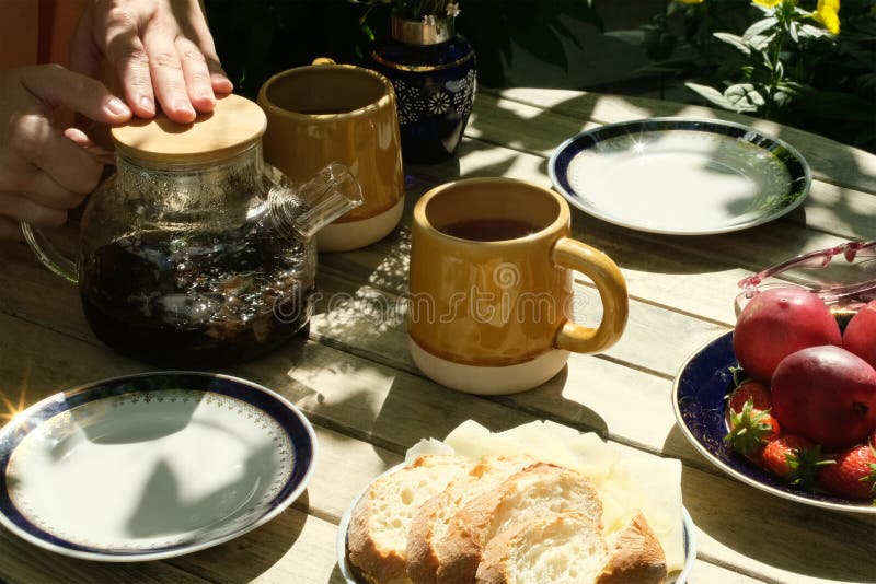 Pouring Tea into Ceramic Mug on Wooden Table Outdoors. Stock Image ...