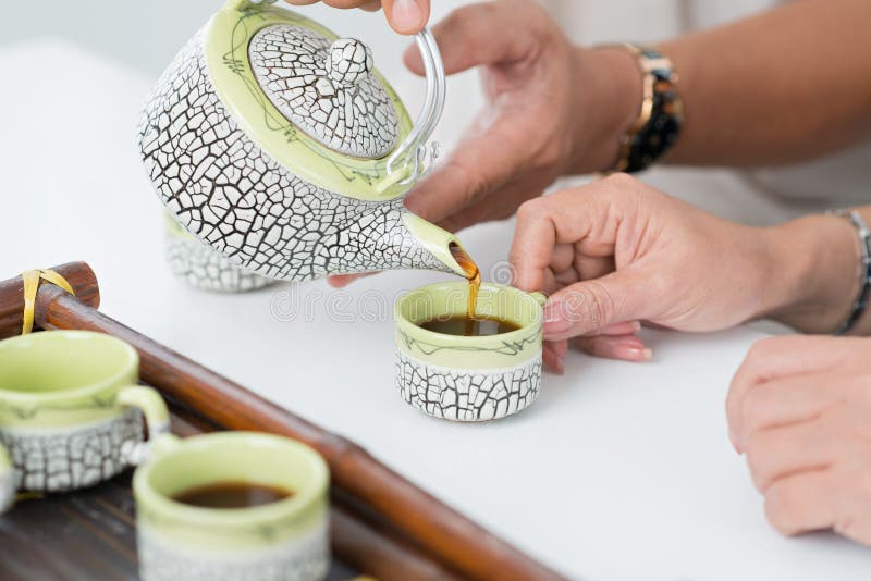 Pouring tea stock image. Image of female, herbal, male - 30961735