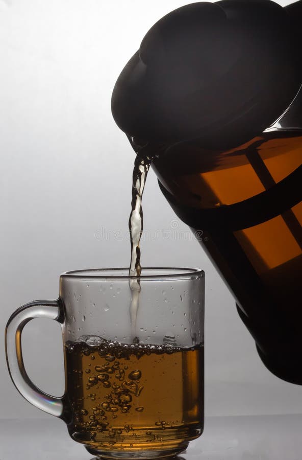 Pouring Tea into Cup of Tee Stock Image - Image of black, herbal: 63797959