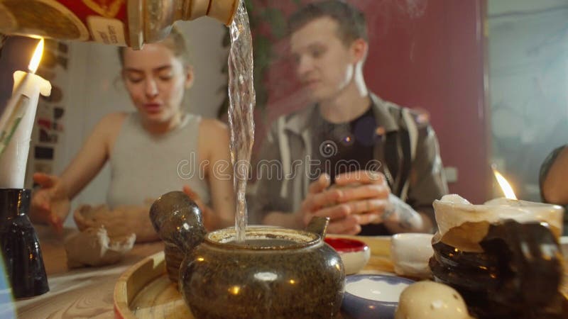 Pouring Tea during a Pottery Class in the Workshop. Fun and Interesting ...