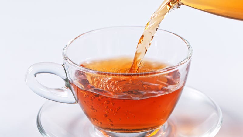 Pouring tea to a teacup stock image. Image of fresh - 210855811
