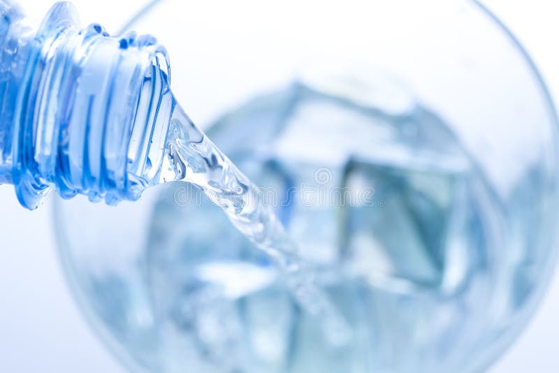 Pouring Water in an Elegant Glass with Ice and Water Drops. Stock Image ...