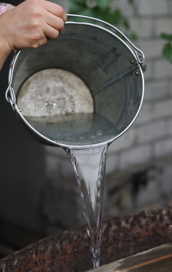 Pouring Water Out of an Iron Bucket. Stock Photo - Image of colours ...