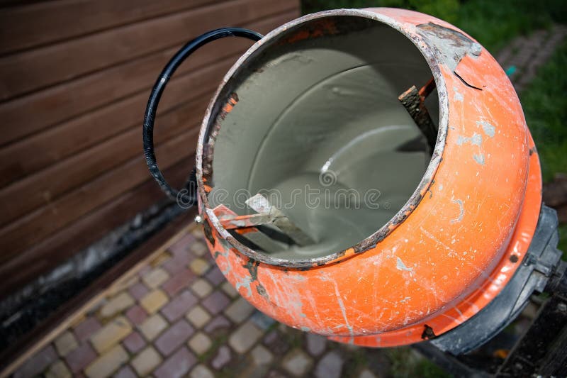 Pouring Wet Concrete from Mixer into Plastic Container at Construction ...