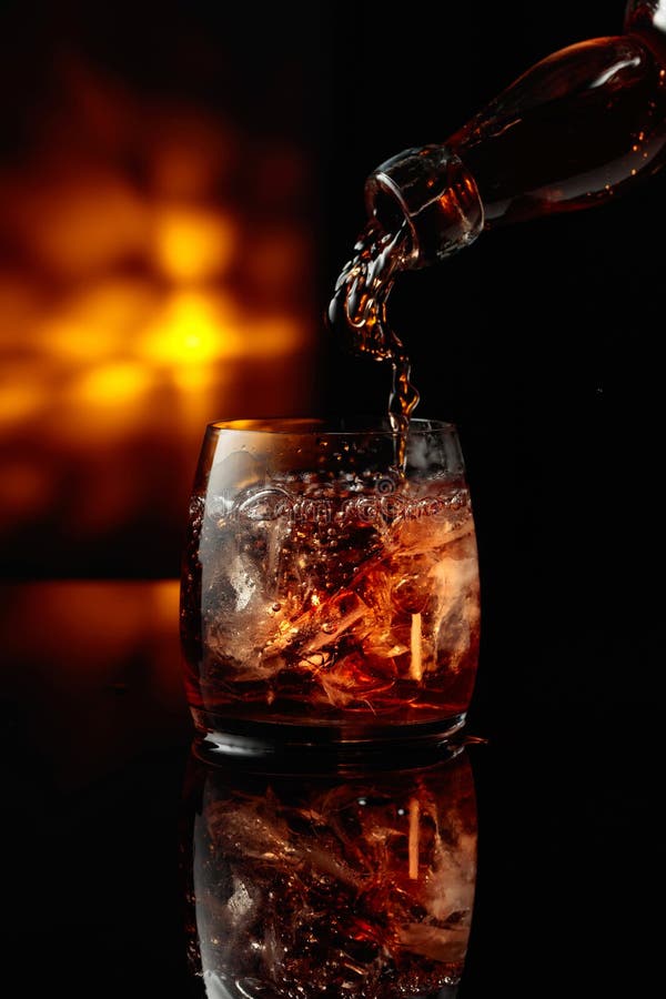 Pouring Whiskey into a Glass with Ice Stock Image - Image of golden ...