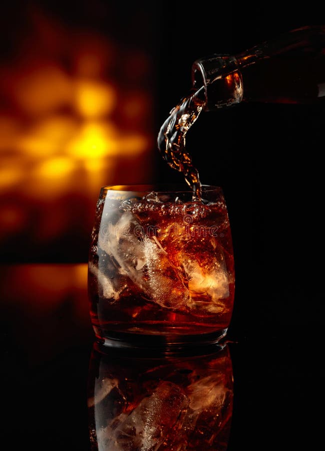 Pouring Whiskey into a Glass with Ice Stock Photo - Image of lifestyle ...