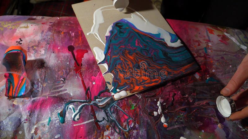 Pouring White Acrylic Near Colored Paint Puddle Creating Fluid Art ...