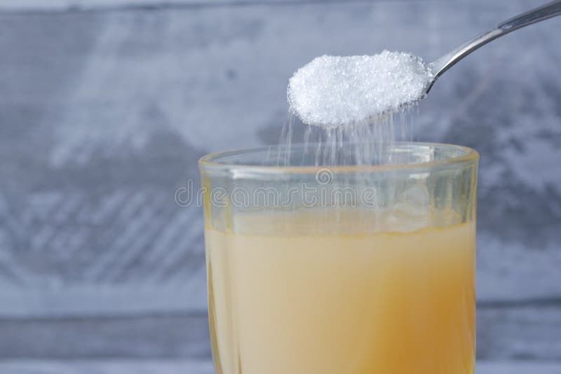 Pouring White Sugar in a Glass of Water on Table Stock Photo - Image of ...