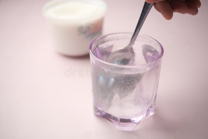 Pouring White Sugar in a Glass of Water on Table Stock Image - Image of ...