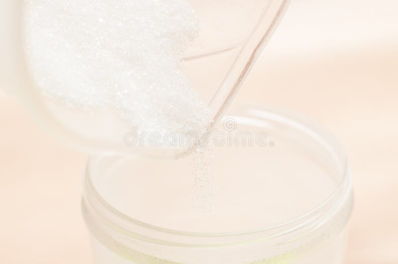 Pouring White Sugar into a Smaller Container for Ease of Use Stock ...