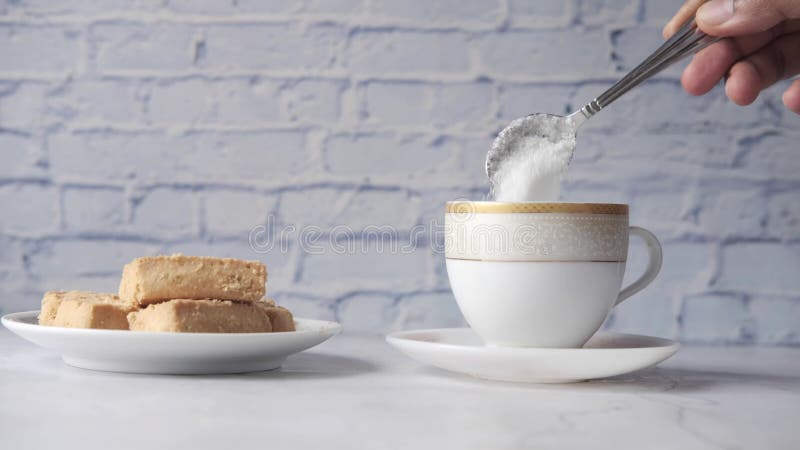 White Sugar Pouring from a in a Paper Packet on a Coffee Cup Stock ...