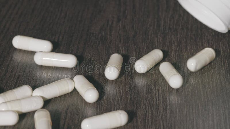 Pouring Tablets Onto the Table from a Jar Stock Video - Video of ...