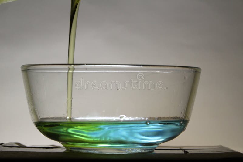 Pouring Yellow into blue stock photo. Image of liqueur - 182479288
