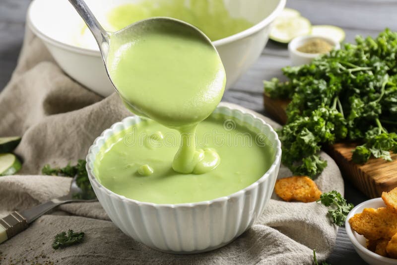 Pouring Squash And Water Into Glasses With A Black Background. Stock ...