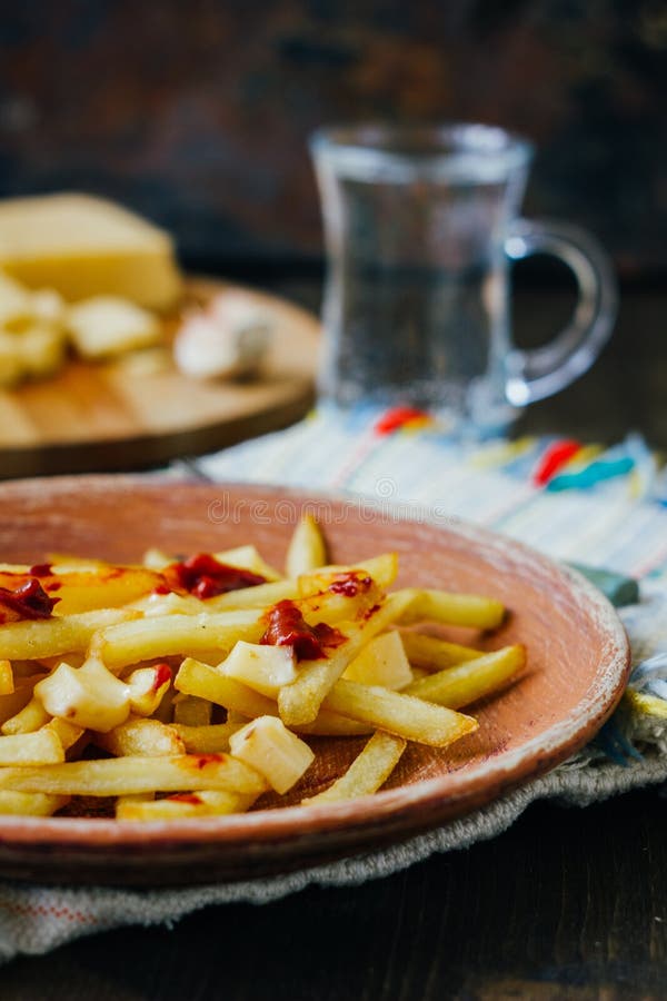 Poutine Fries on Black Surface. Canadian Dish with Potatoes, Cheese and ...
