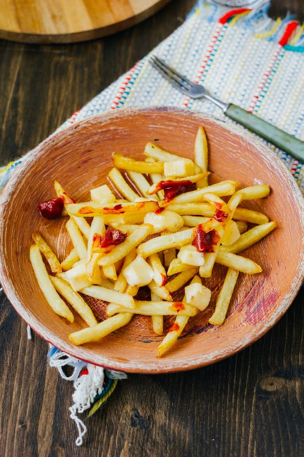 Poutine Fries on Black Surface. Canadian Dish with Potatoes, Cheese and ...