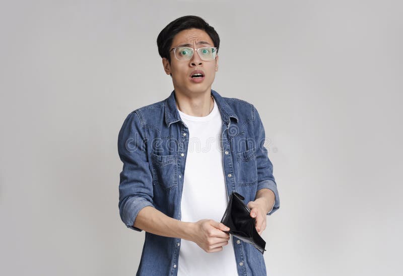 Poverty and Absence of Money. Worry Asian Guy Showing Empty Wallet ...