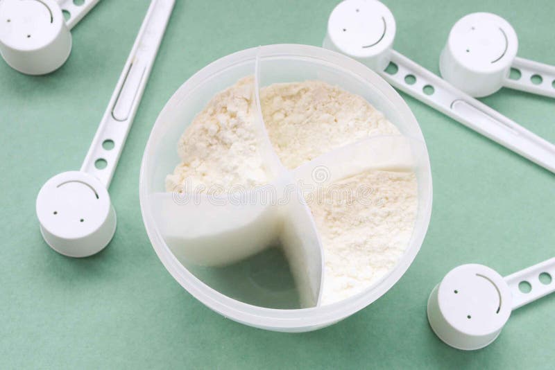 Powdered Infant Formula in a Container and Spoon for Feeding. Container ...