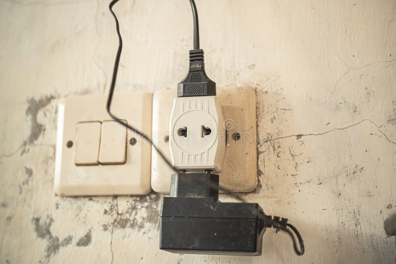 A Power Adapter Plugged into a Wall Outlet Stock Photo - Image of ...