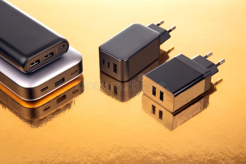 Power Bank and Charging Plug on a Golden Background. Electronic Devices ...