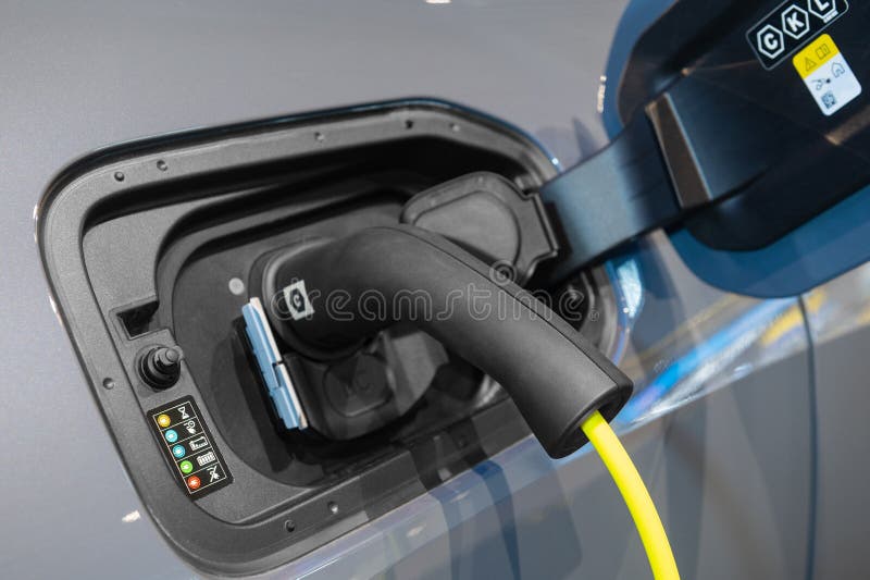 Power Cable Connected with a Charger Plugged into Electric Car Stock ...