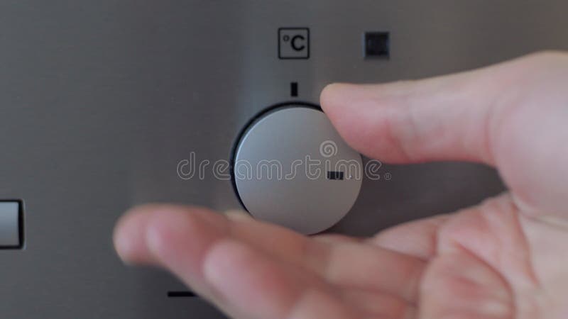 Person Turning on a Button on an Appliance. Temperature Increase in the ...