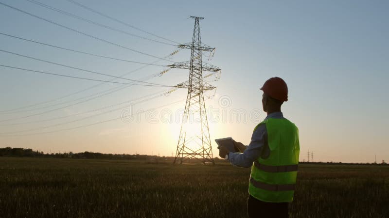 A Power Engineer in Special Clothes Holds a Table. Stock Footage ...
