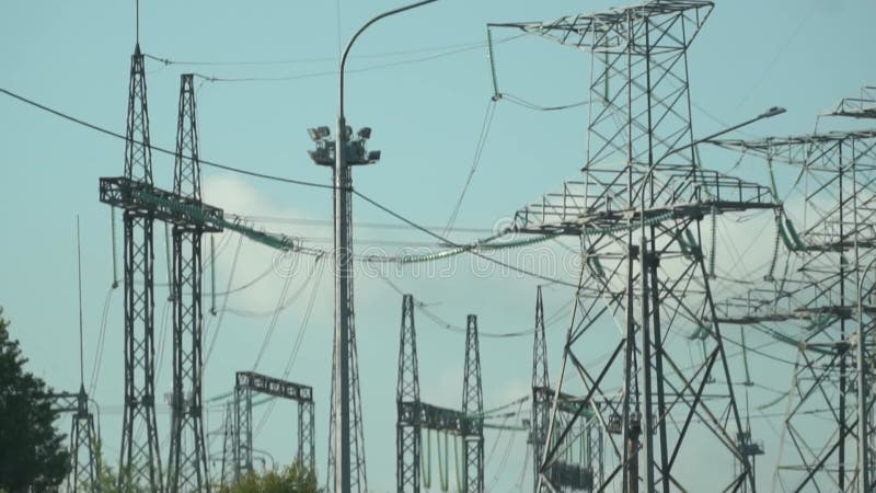 A Power Grid with Many Tall Poles and Wires. the Sky is Clear and Blue ...
