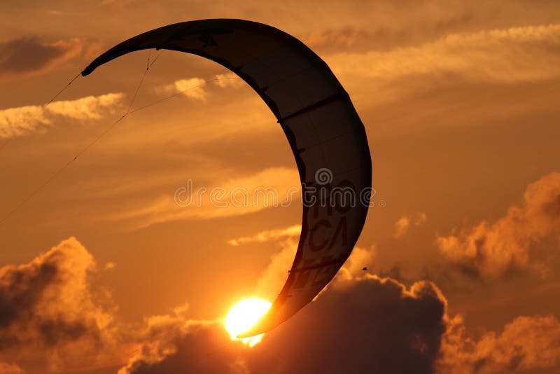 A Power Kite Surfer Swimming in the Lagoon Against the Backdrop of a ...