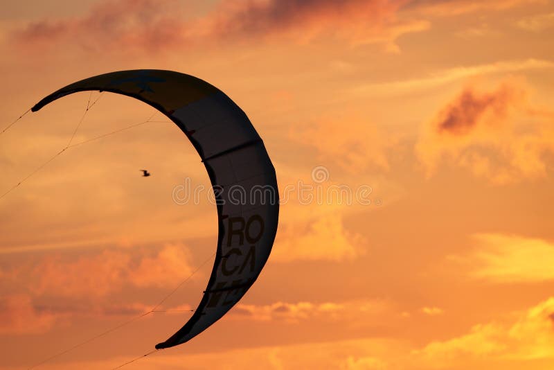 A Power Kite Surfer Swimming in the Lagoon Against the Backdrop of a ...